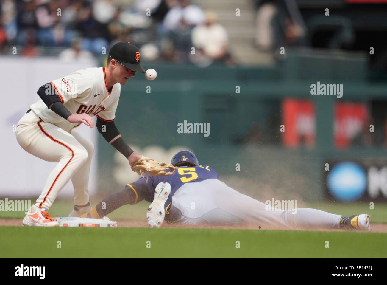 Milwaukee Brewers' Garrett Mitchell, bottom, steals second base against ...