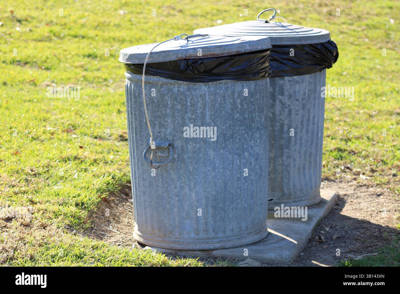 dingy silver trash can at park Stock Photo - Alamy