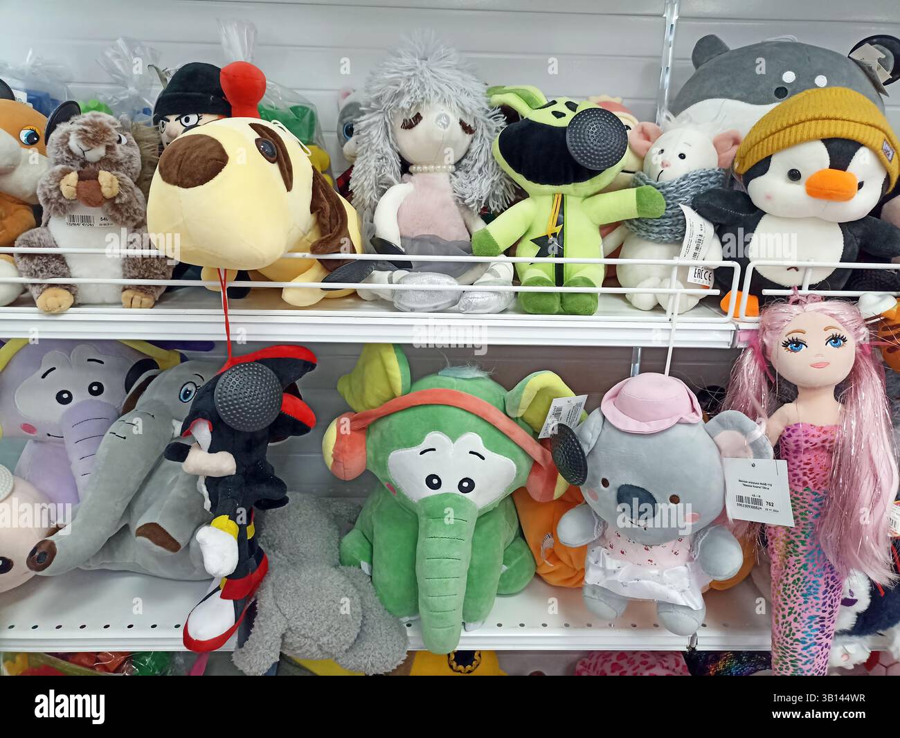Colorful assortment of plush toys on display shelves in a toy store ...