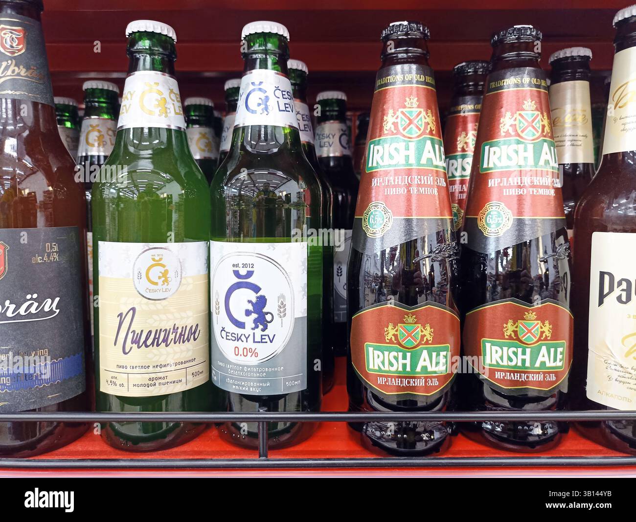 Variety of international beer bottles displayed on store shelf Stock ...
