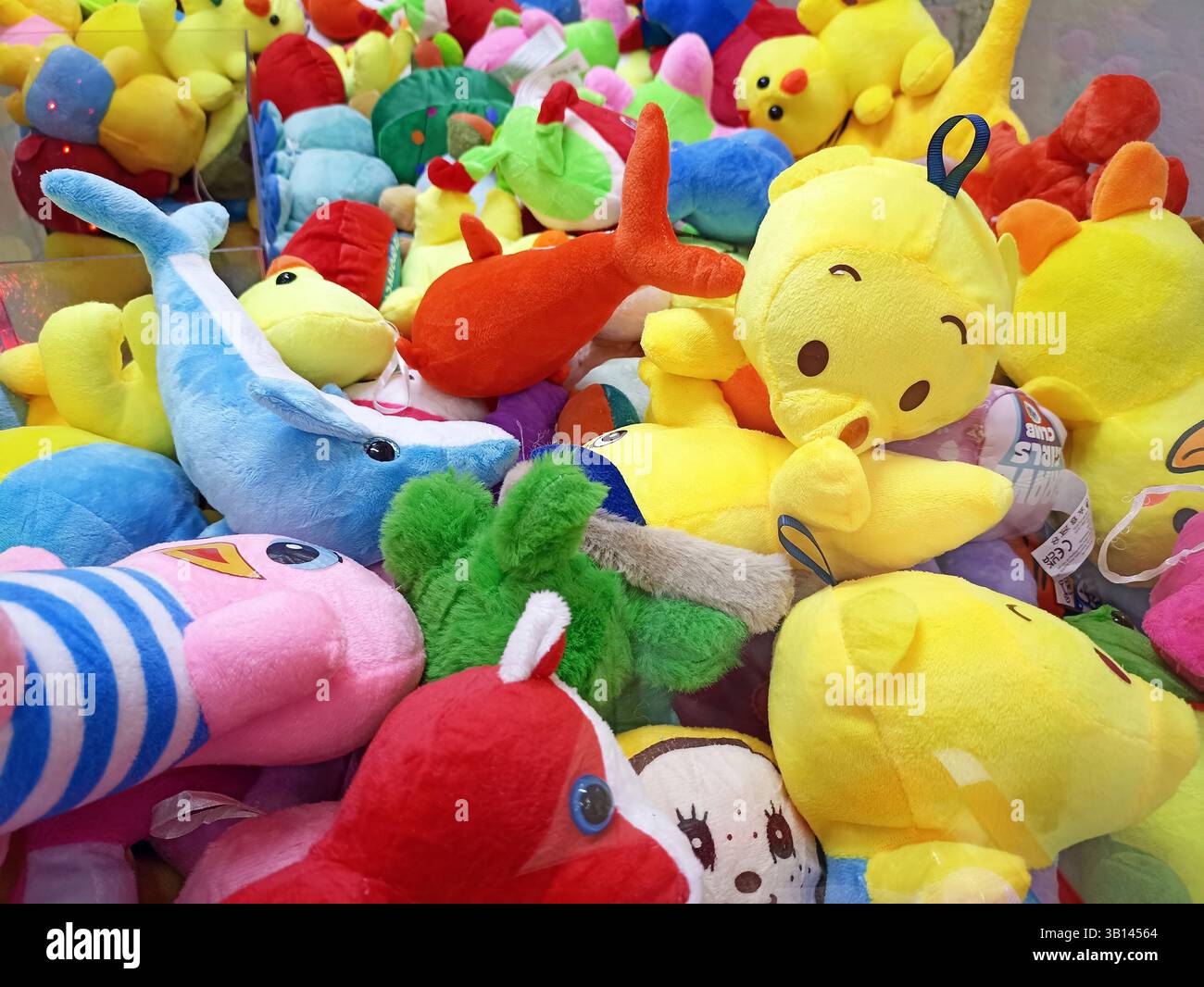 Vibrant plush toy collection with colorful animals in claw machine ...