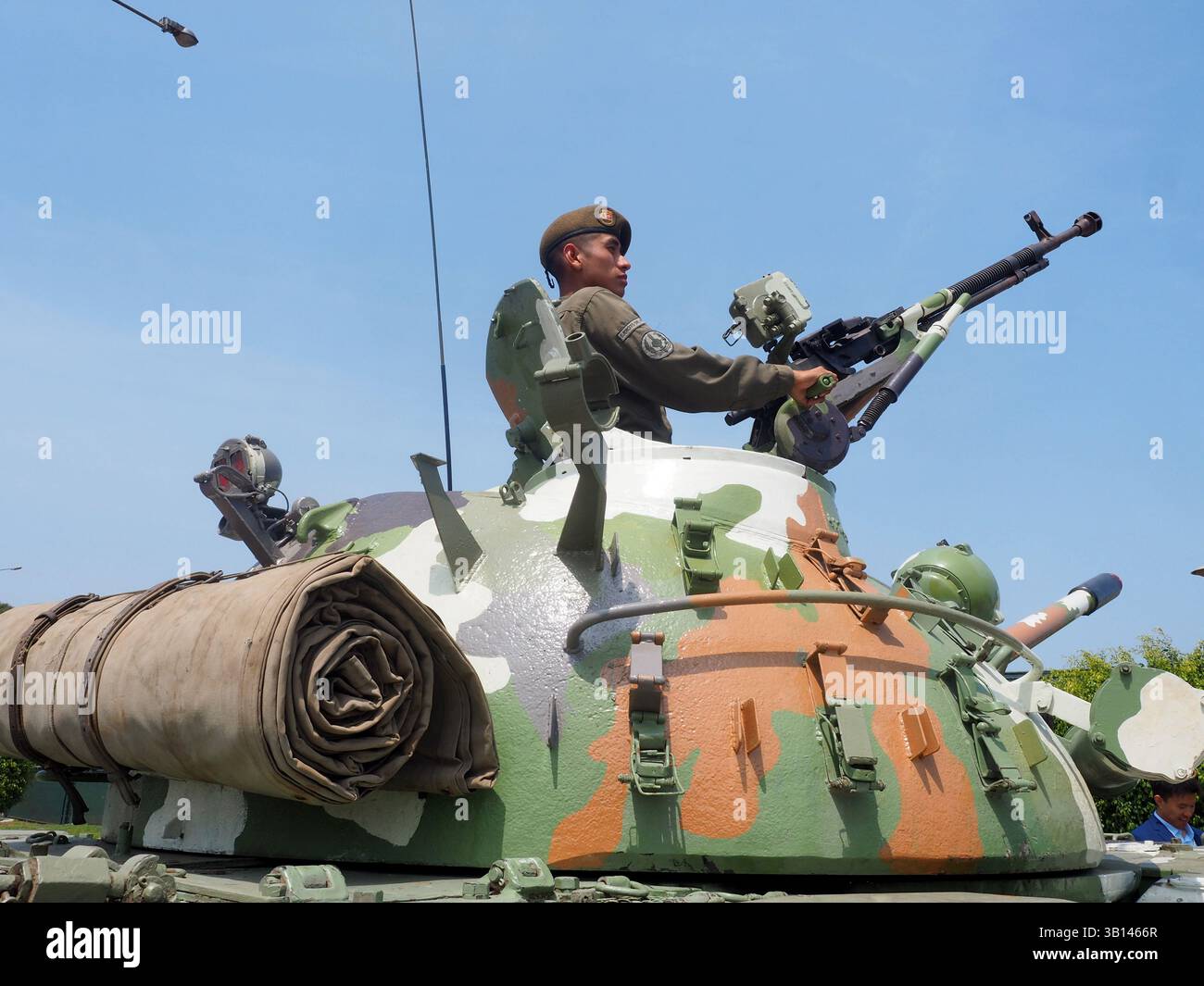 Soldier manipulating a machine gun in the turret of a Soviet-made T-55 ...