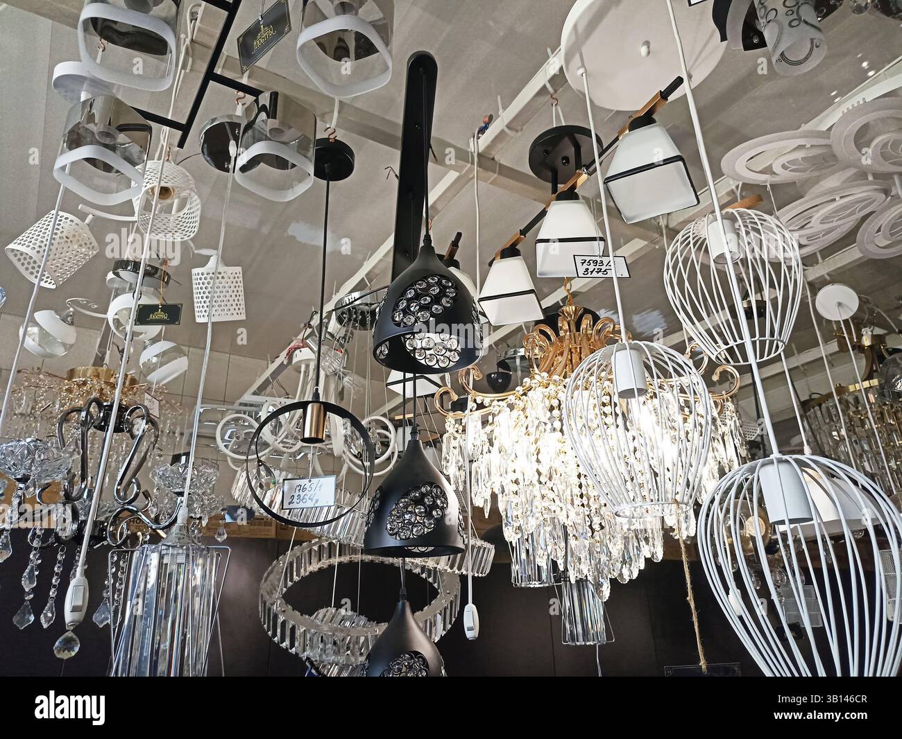 Variety of modern chandeliers and light fixtures on display in a ...