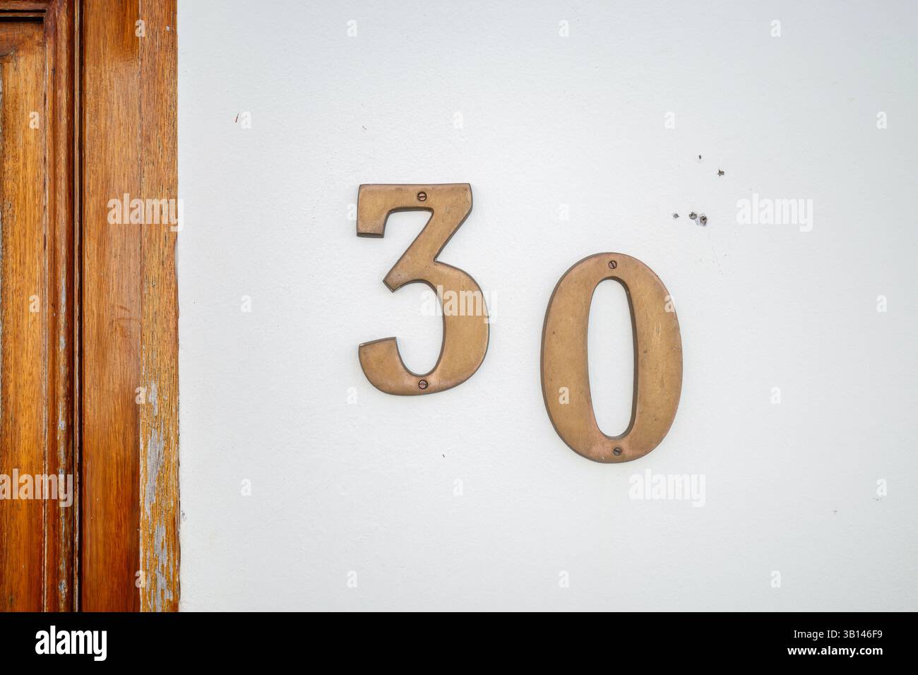 Vintage Brass House Number 30 on White Stucco Wall with Rustic Wooden ...