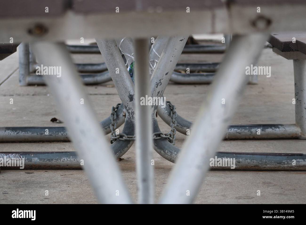 metal pole supports under table Stock Photo - Alamy