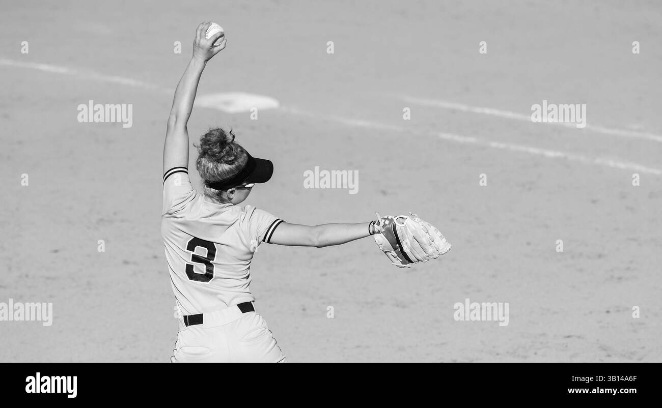A Fast Pitch Softball Pitcher Is In Full Wind Up Pitching The Ball ...