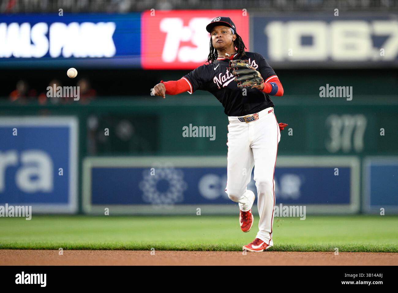 Washington Nationals shortstop CJ Abrams throws to first base to put ...