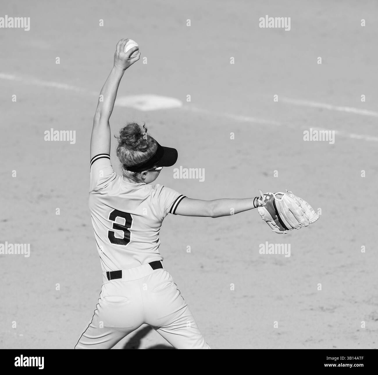 A Fast Pitch Softball Pitcher Is In Full Wind Up Pitching The Ball ...