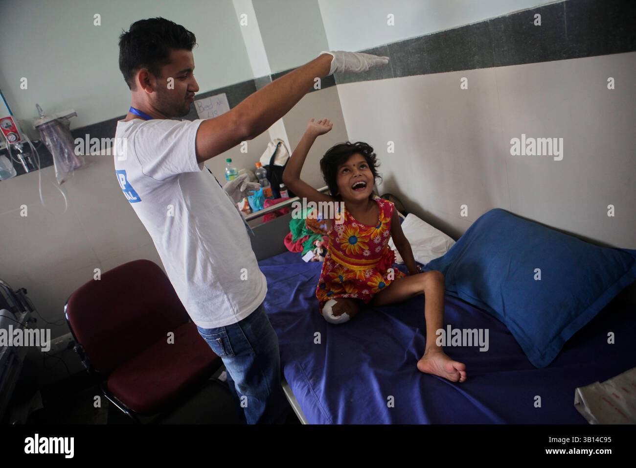 A physiotherapist works with Nirmala Pariyar at the trauma center of Bir Hospital in Kathmandu ...