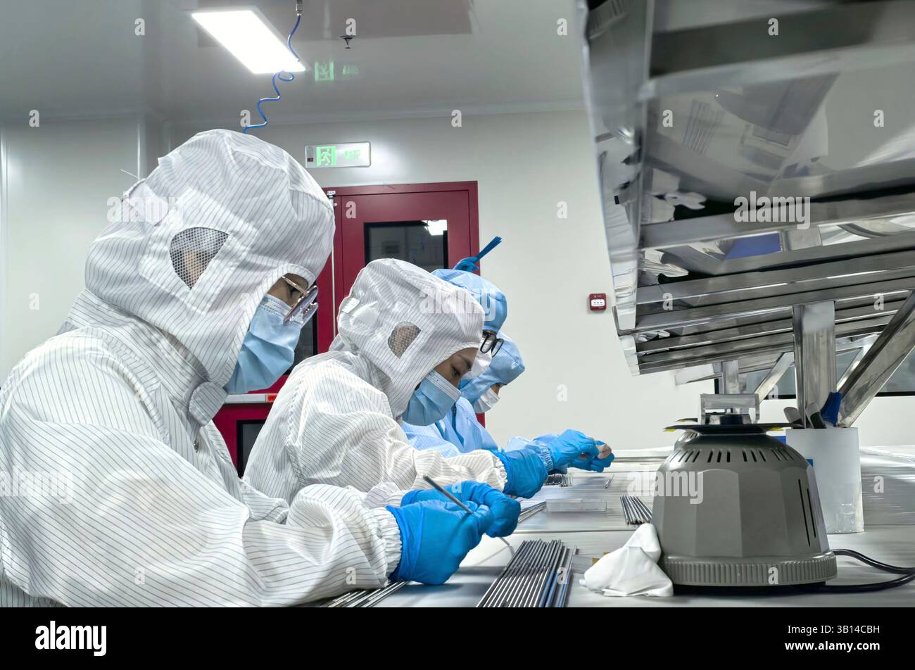 People work at a manufacturer of medical polymer precision catheters in ...