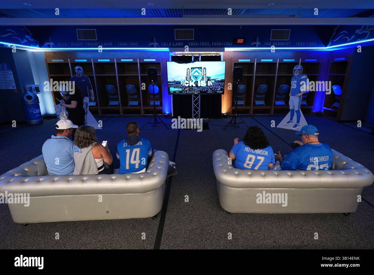 Season ticket holders watch the draft in the Detroit Lions locker room ...