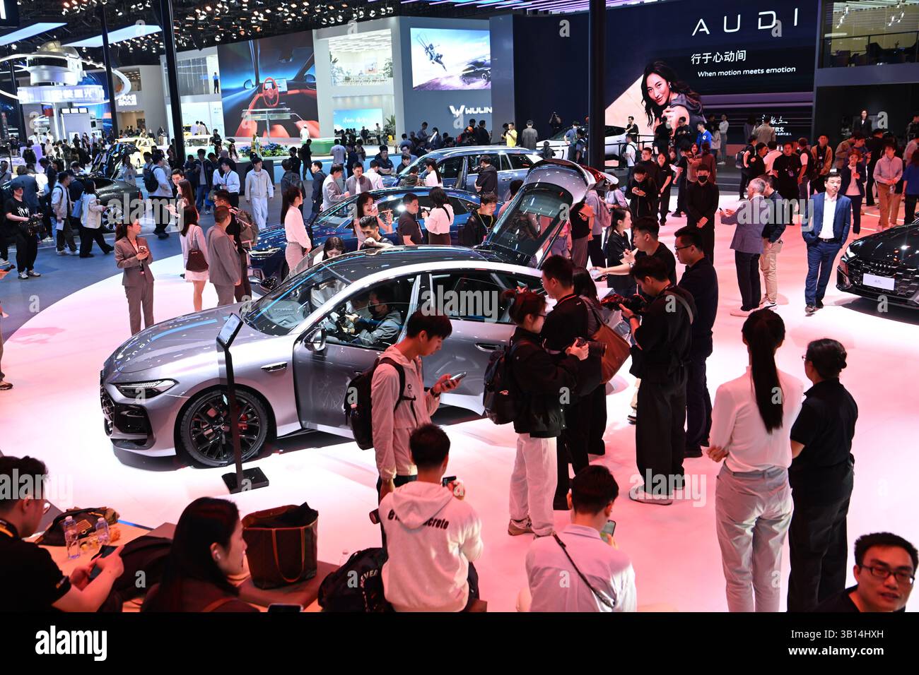 Visitors visited a model displayed at the Audi booth at the 2025 ...