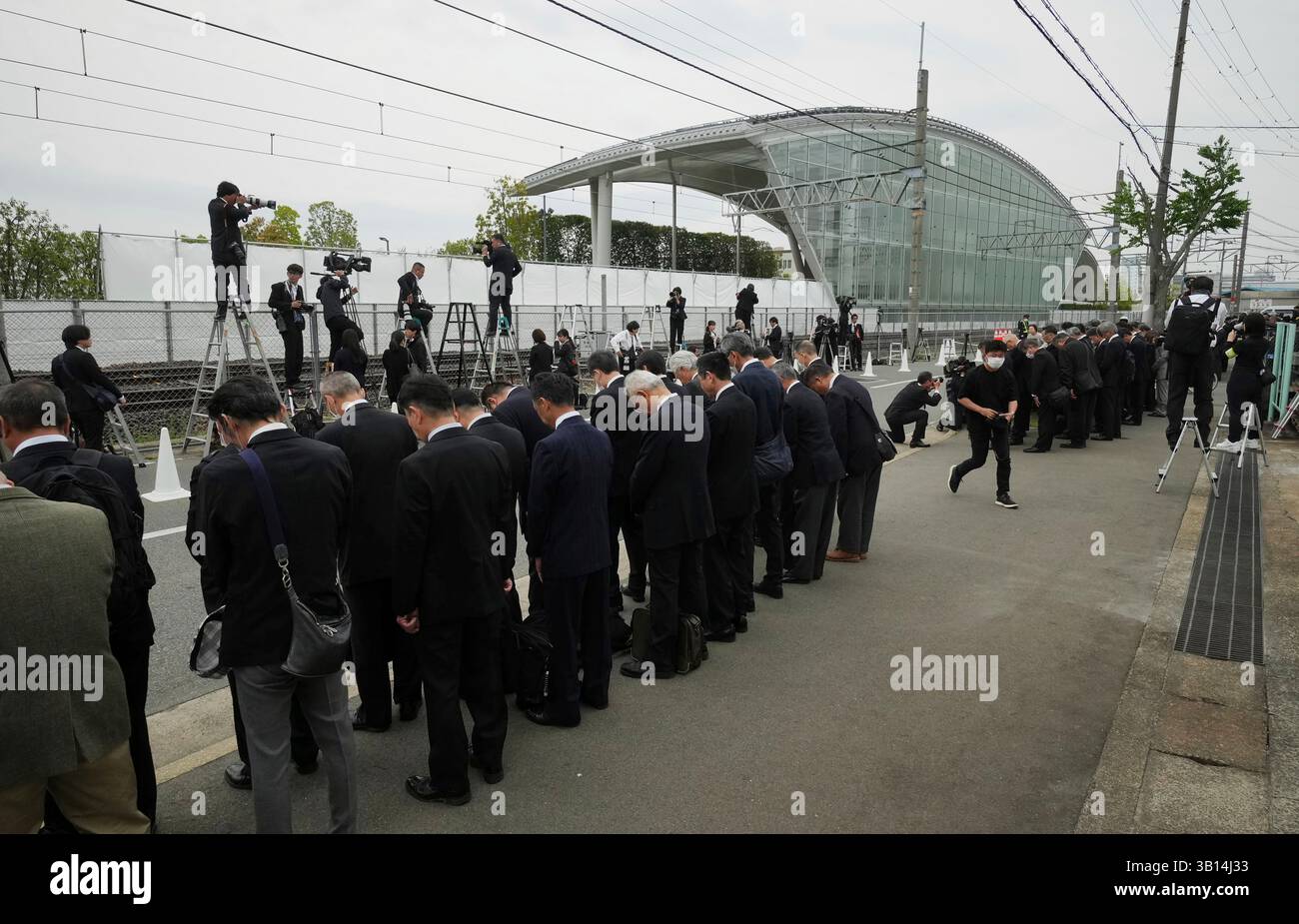 People pray for the victims of a train derailment accident 20 years ago in Amagasaki City, Hyogo ...