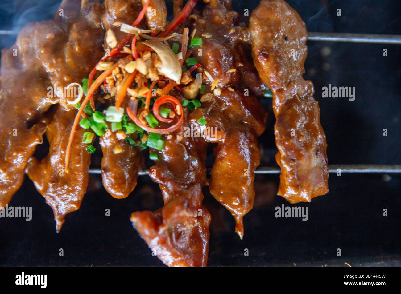 Indonesian Satay being served on a mini grill Stock Photo - Alamy