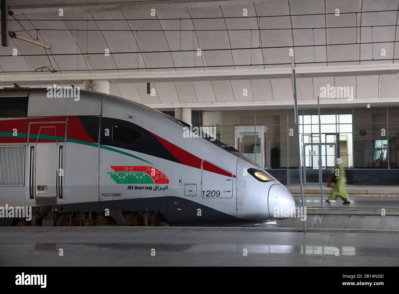 Rabat, Morocco. 20th Apr, 2025. A woman walks past a high-speed train ...