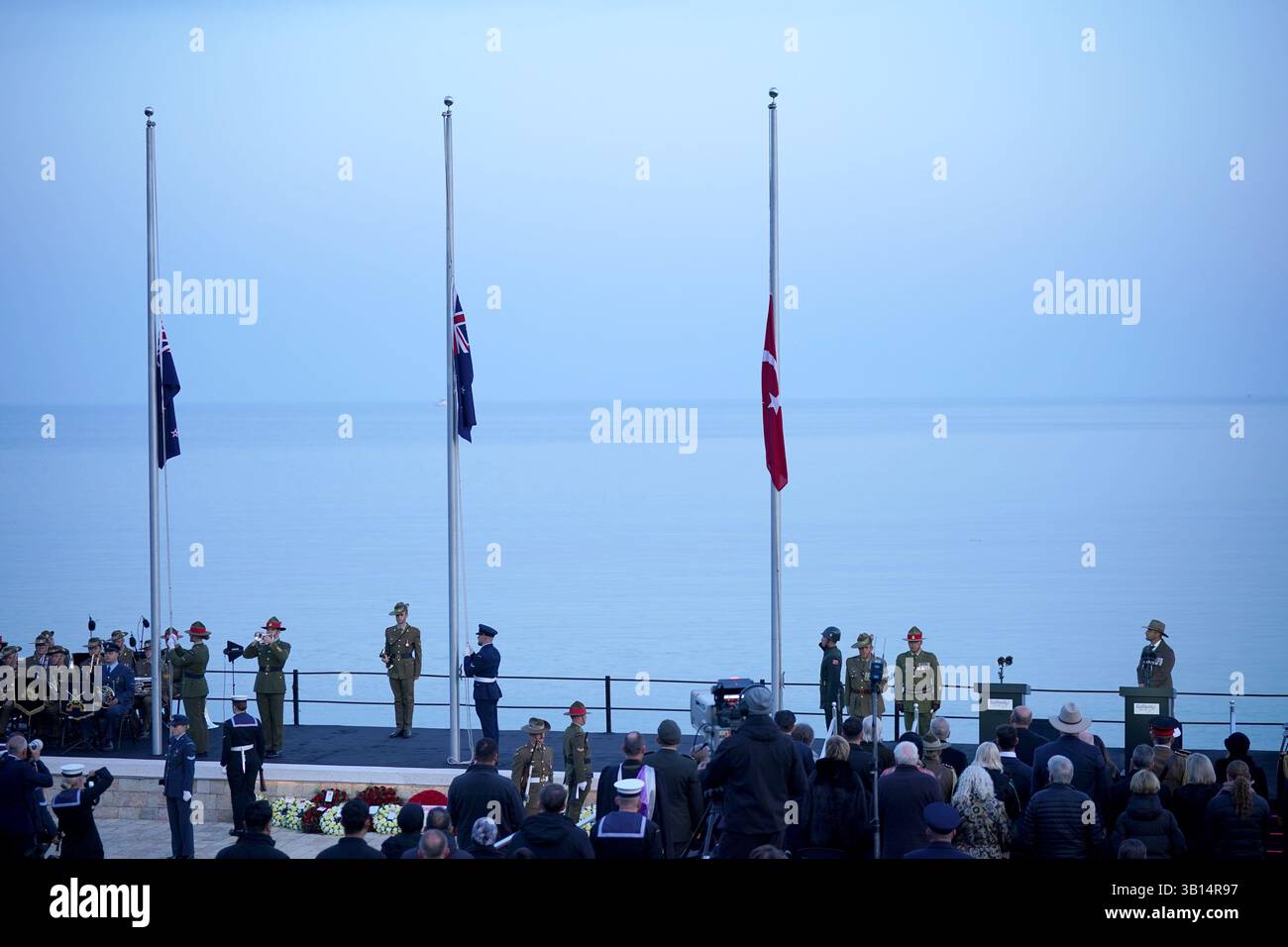 Flags are raised at the dawn memorial service at Anzac Cove on the ...
