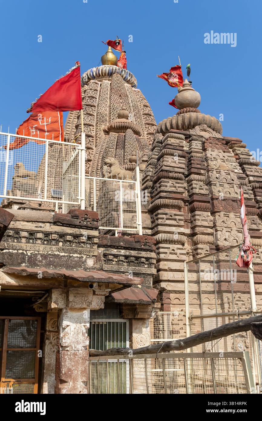ancient hindu temple with waving holy flag and bright blue sky ...