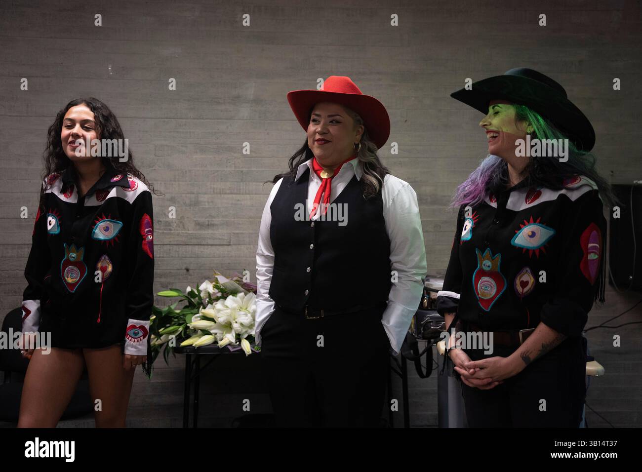Mexican corridos singer Vivir Quintana, center, stands with her band ...