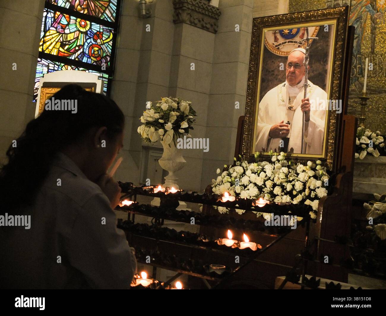A woman prays intently for the repose of the soul of Pope Francis ...