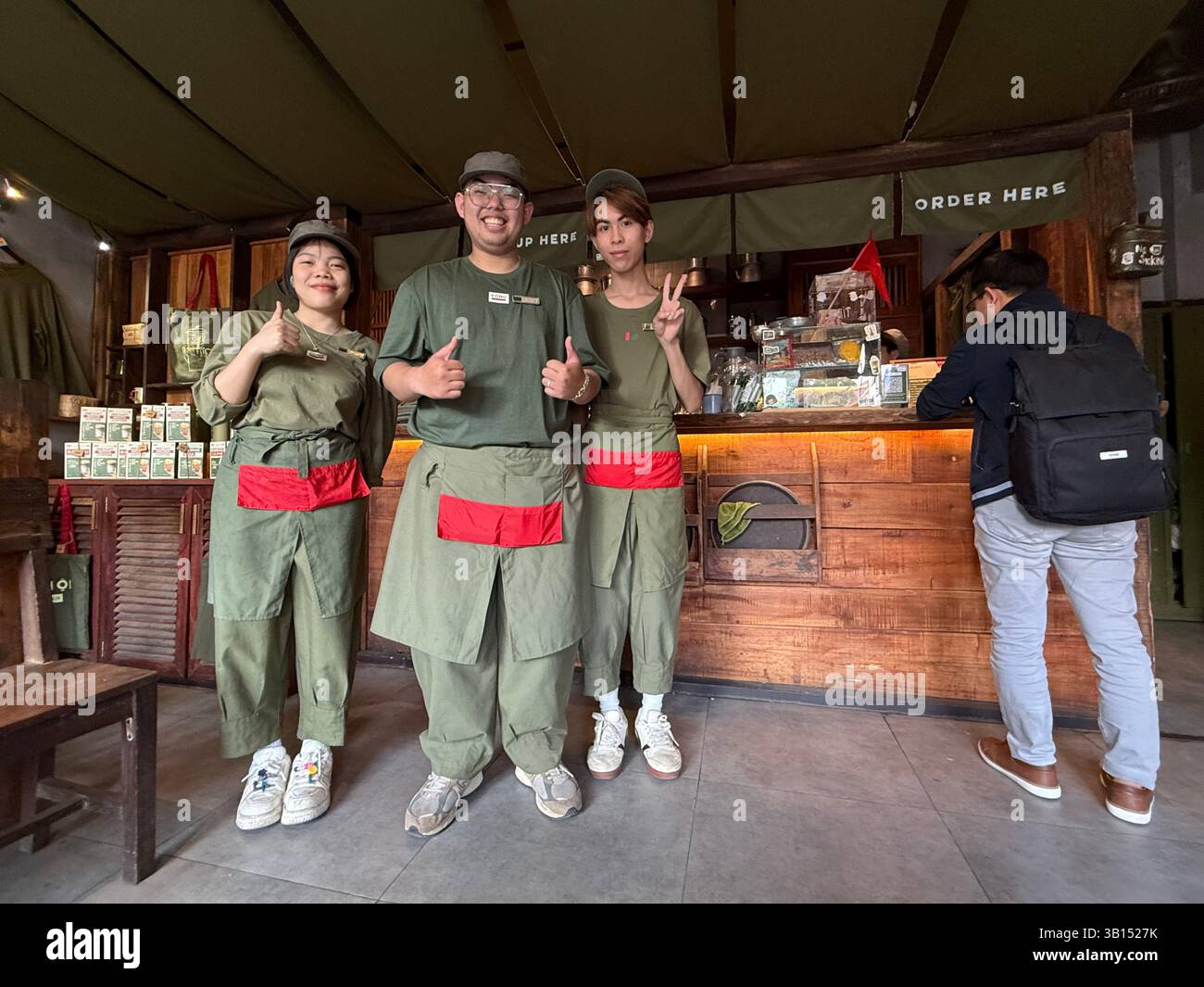 Hanoi, Vietnam. 14th Apr, 2025. Employees in Viet Cong outfits stand in ...