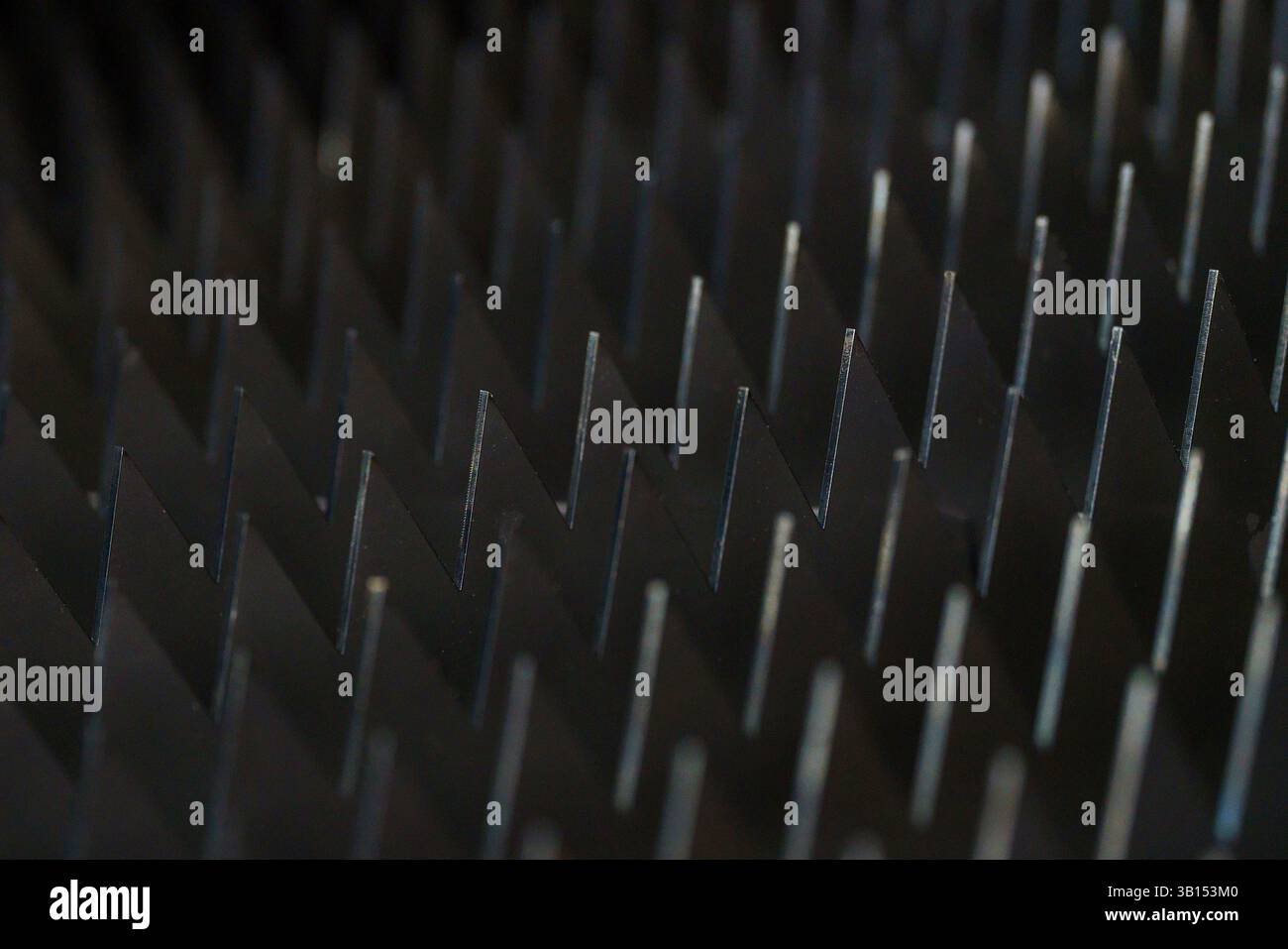 a macro sharp metal teeth, total black background, closeup steel metal ...