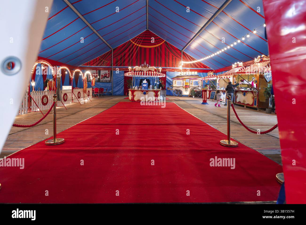 Interior view of a circus tent with red carpet and blue ceiling ...