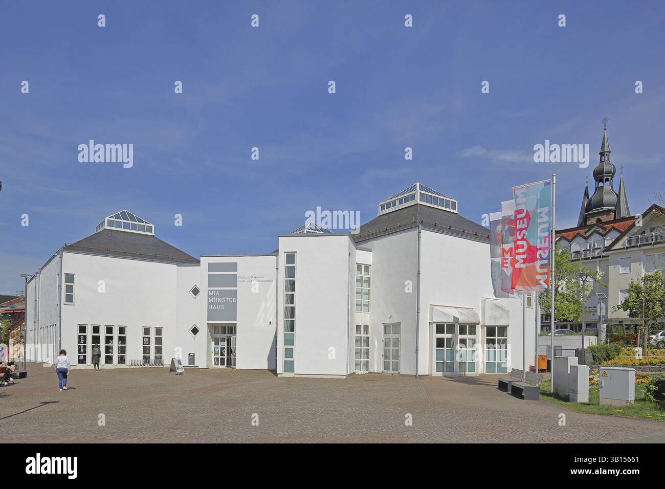 Modern white building with flags and inscription museum, banner, church ...