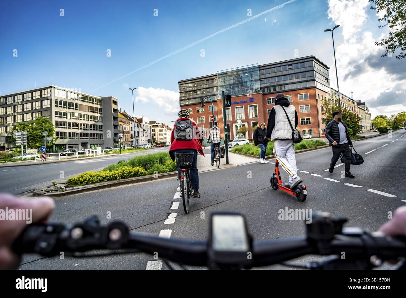 Cycling in the city, inner-city road, cyclist, e-scooter at pavement ...