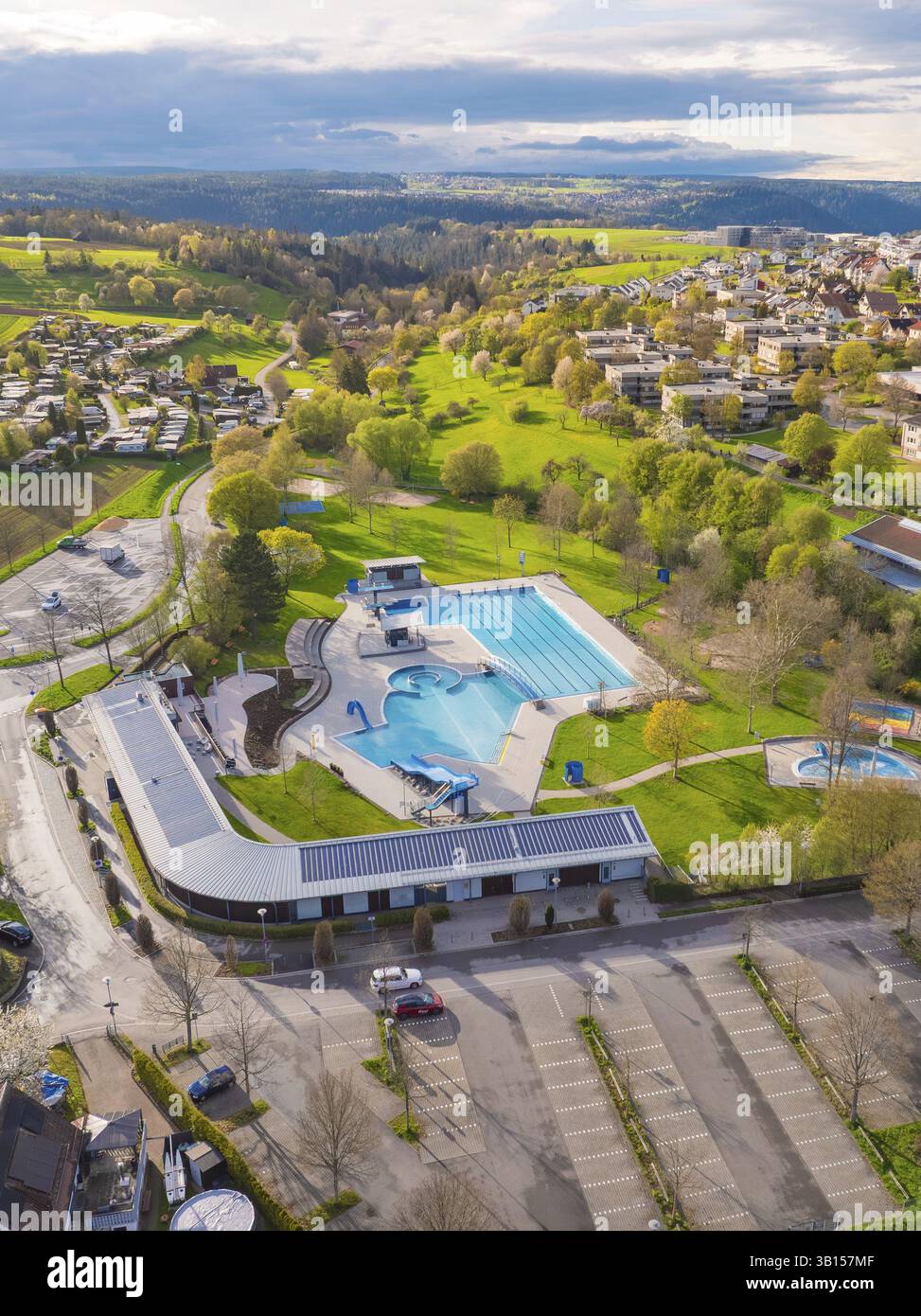 Urban view of an outdoor swimming pool with car park and surrounding ...