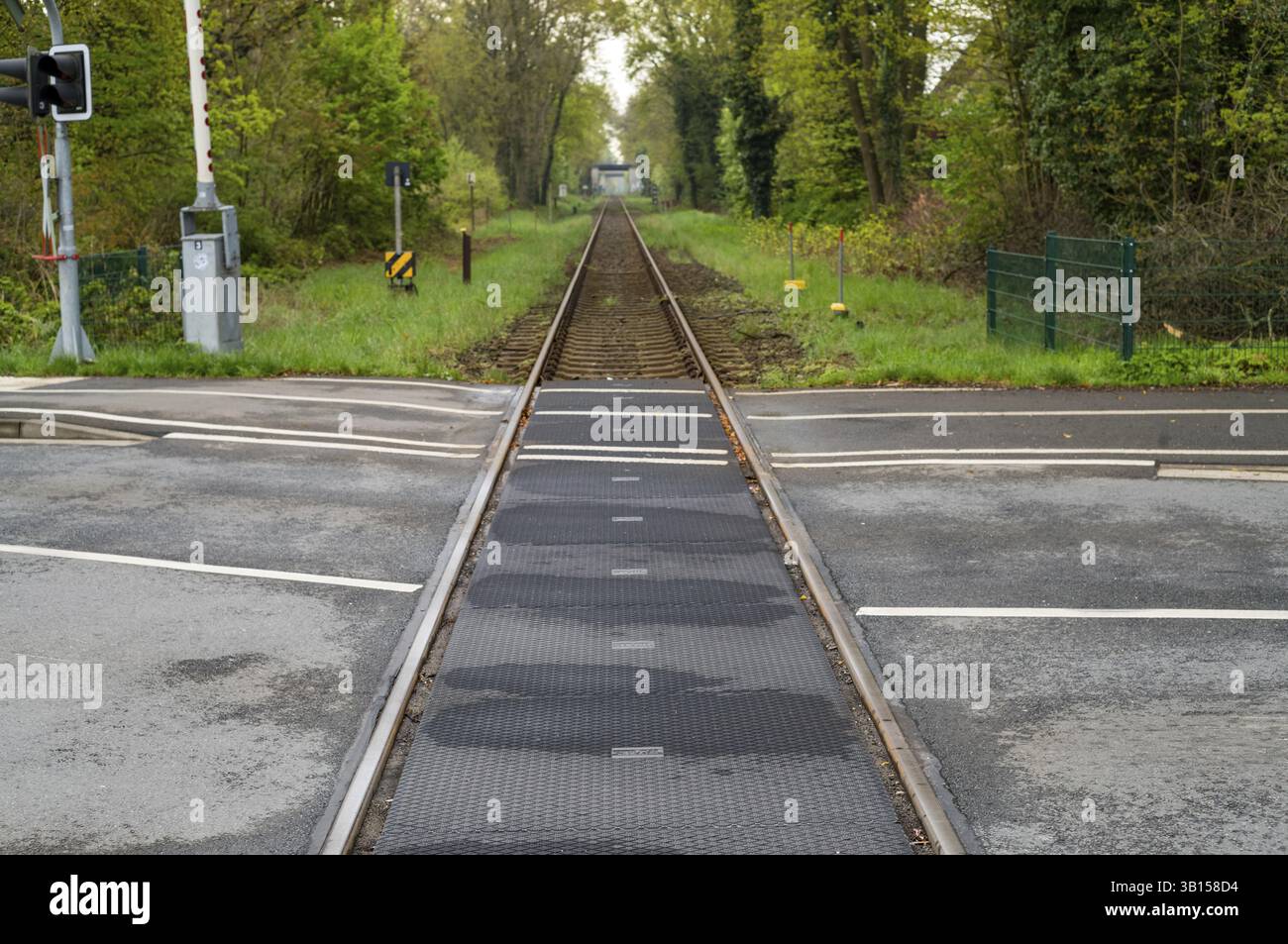 Empty railroad crossing in a rural area with traffic lights and ...