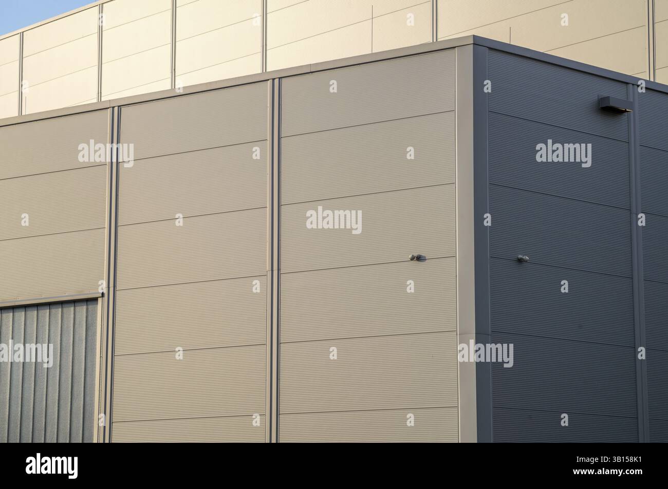 Sandwich panel industrial building facade featuring visible security ...