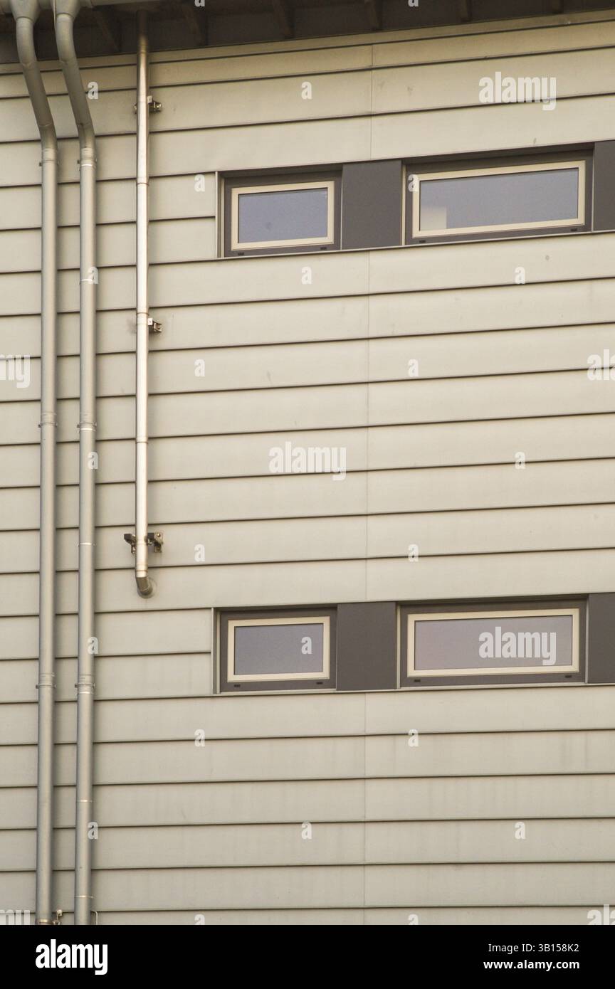 Metal cladding and rectangular windows create a contemporary ...