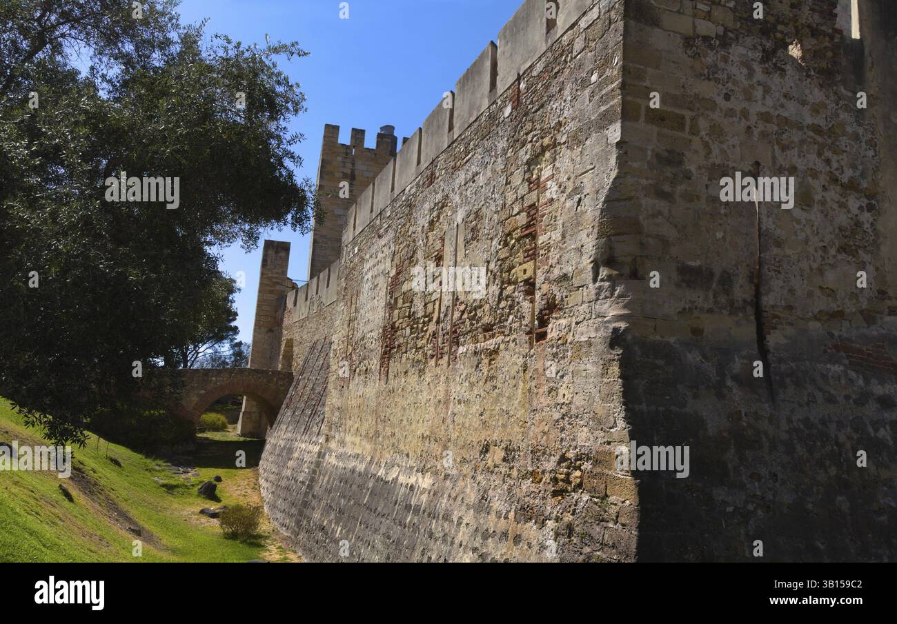 Exterior view of the medieval Sao Jorge Castle surrounded by thick ...