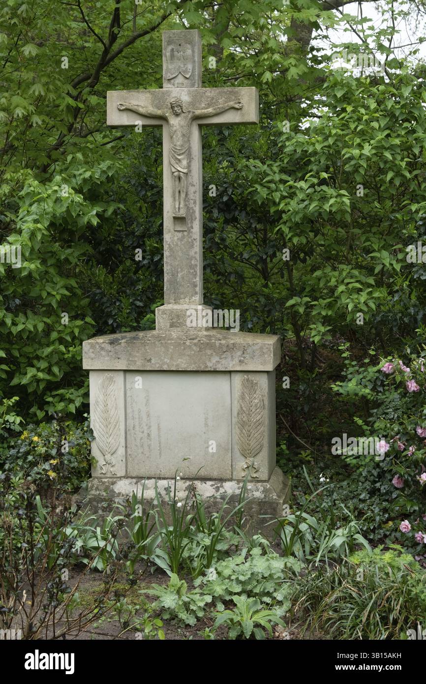 Stone cross commemorating the deceased, located in a peaceful cemetery ...