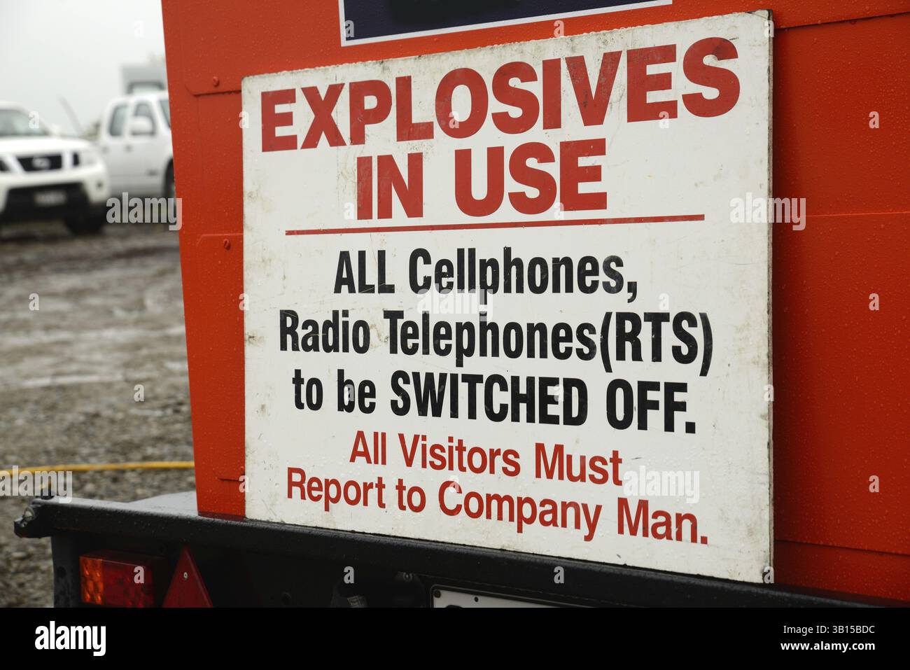 Signage warns visitors of the use of explosives as oil well engineers ...