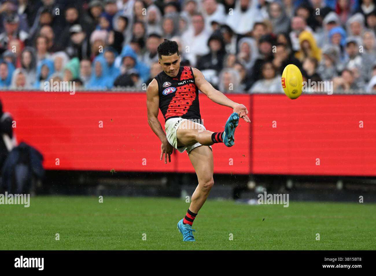 Melbourne, Australia. 25th Apr, 2025. Isaac Kako of Essendon kicks the ...
