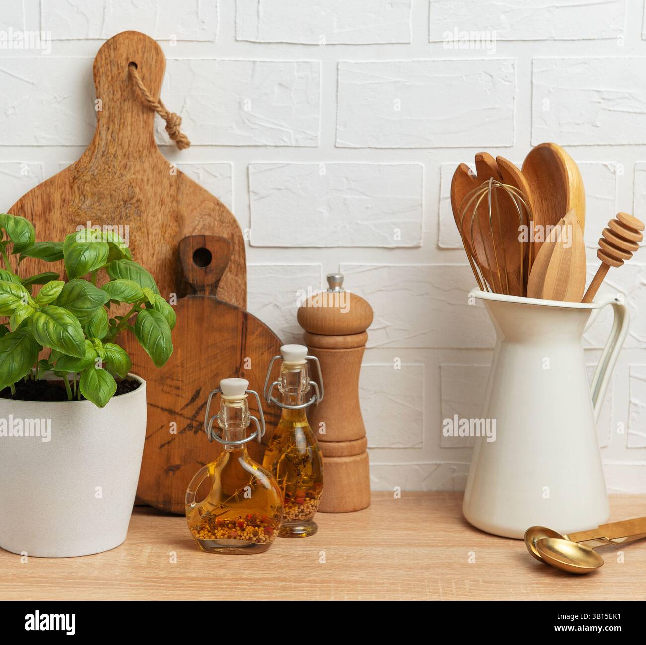 Cozy kitchen setup featuring basil, utensils, and wooden accents Stock ...