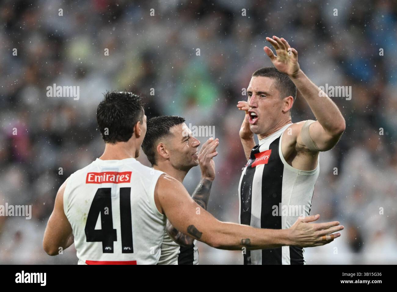 Darcy Cameron of Collingwood celebrates with team mates after kicking a ...