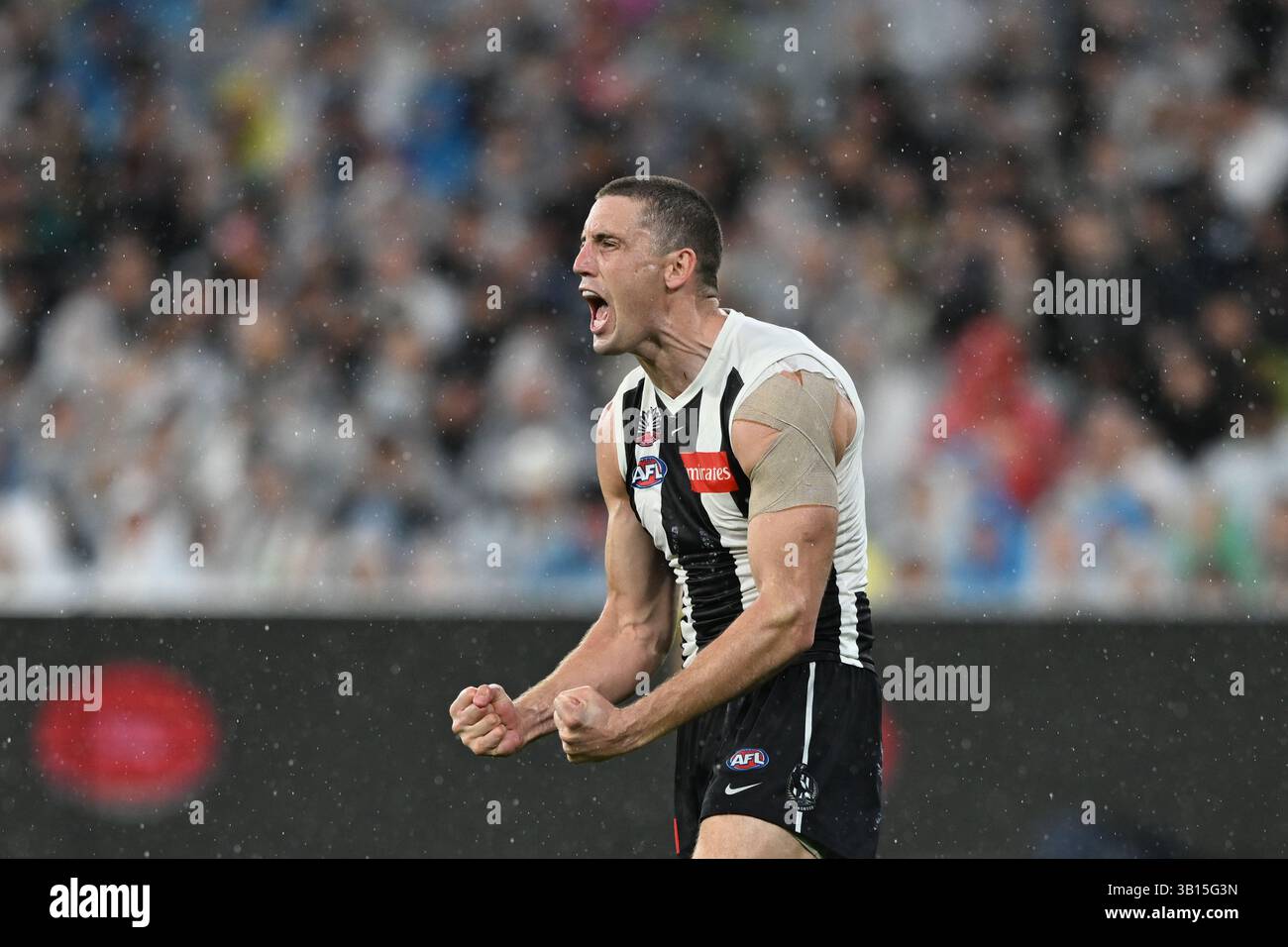 Darcy Cameron of Collingwood celebrates with team mates after kicking a ...