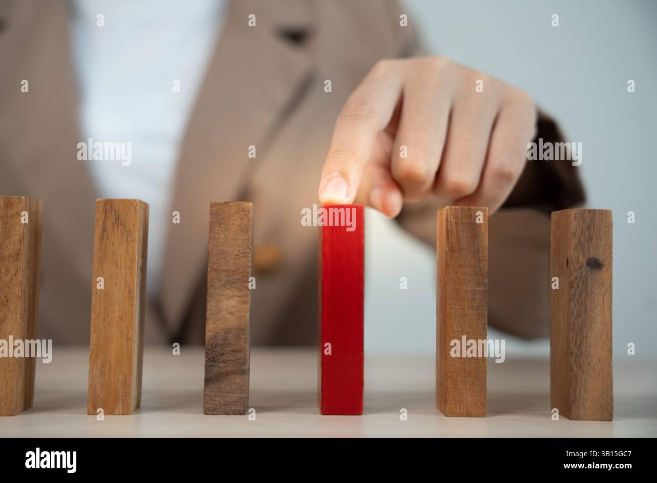 insurance with hands protect domino. Businessman hands stop dominoes ...