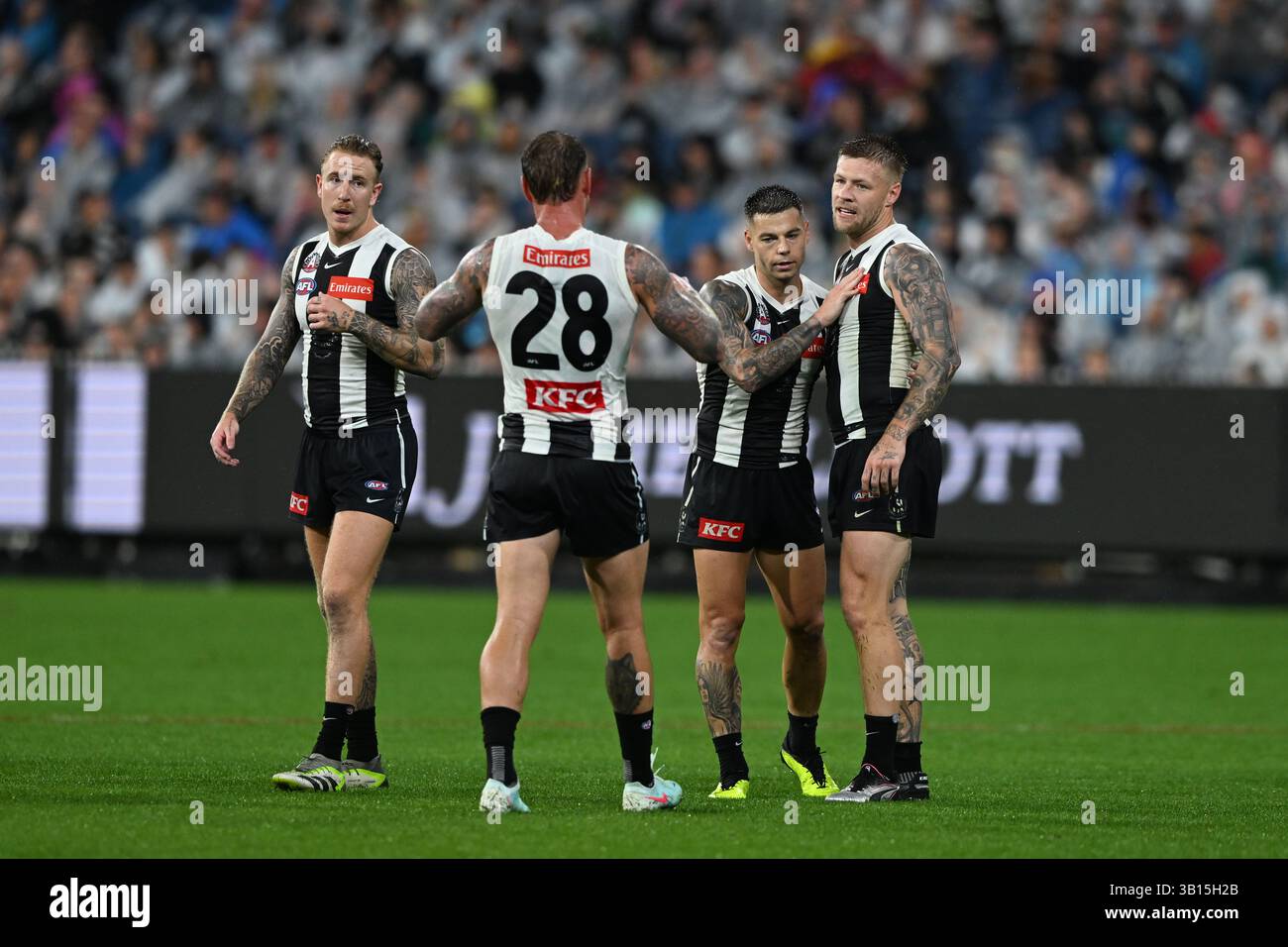 Jamie Elliott of Collingwood (2nd right) celebrates with team mates ...