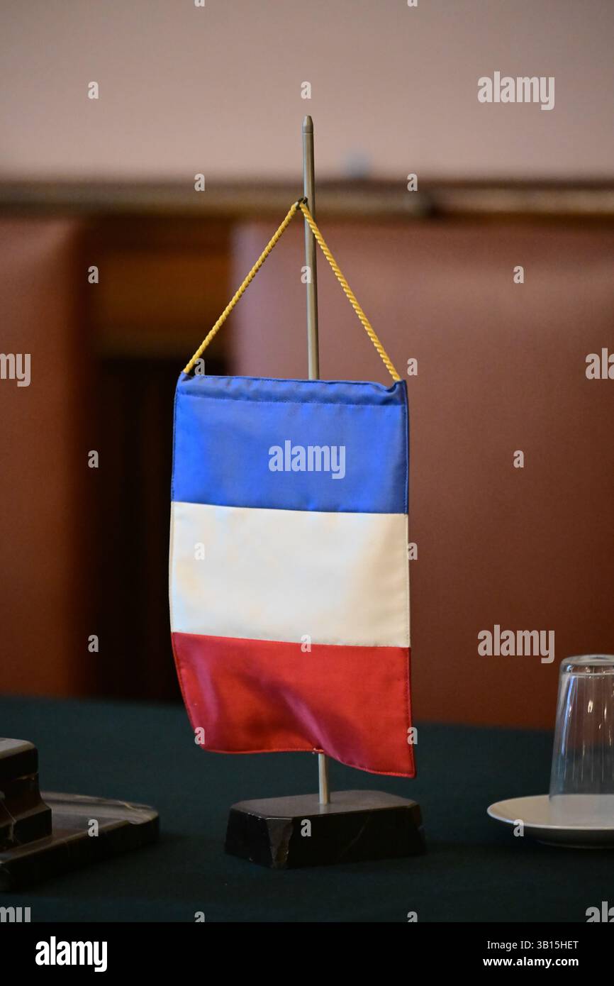 PRODUCTION - 24 April 2025, Berlin: A replica of a small French flag is ...