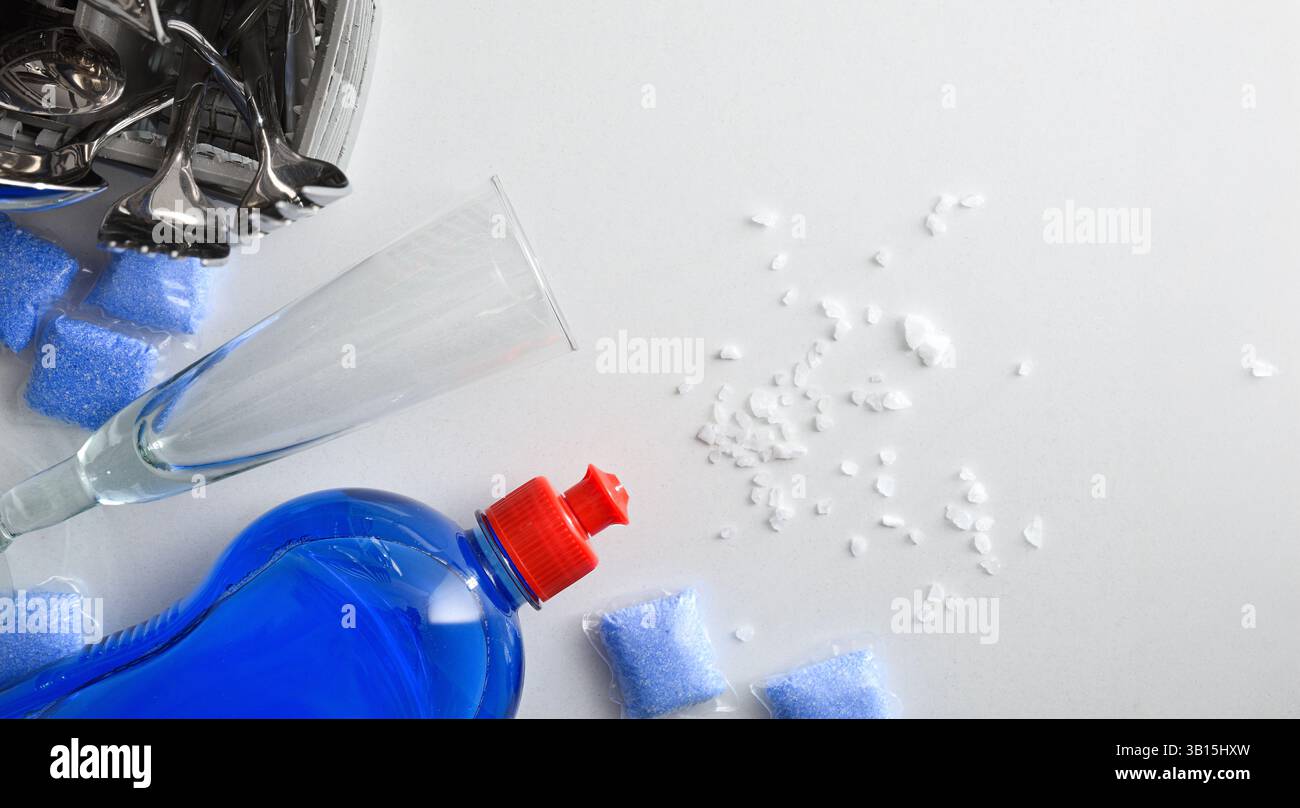 Detail of dishwasher products on white table like detergent in pods ...