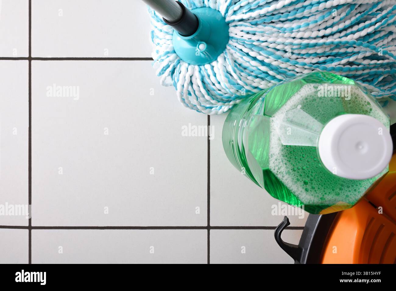 Bottle with green disinfectant products for tile floors, mop with ...