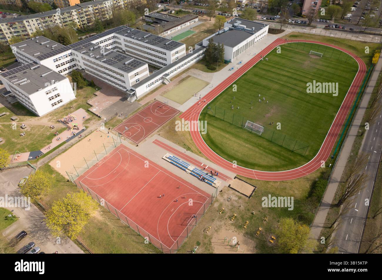 School Complex with Sports Fields and Urban Landscape - Aerial View ...