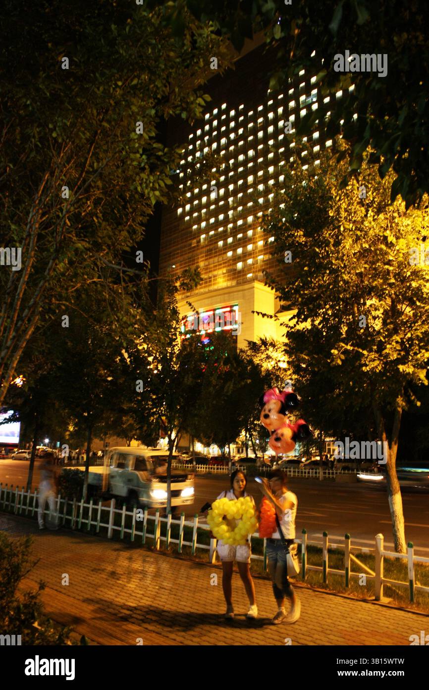 Night Street Scene in Urumqi, Young People with Balloons and City ...