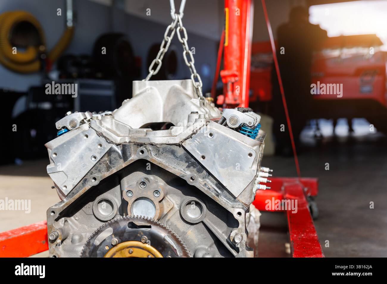 Motorsport pit lane garage box paddock hanged v8 engine suspended crane ...