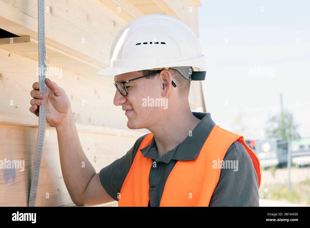 Wood technician working with wood outside Stock Photo - Alamy
