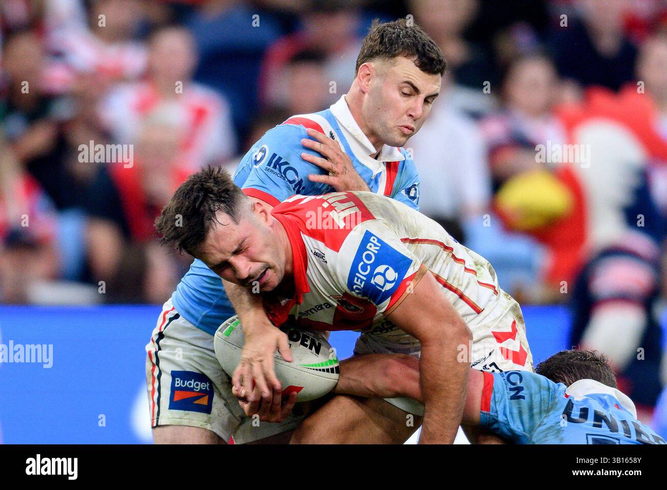 Lachlan Ilias of the Dragons by Sandon Smith of the Roosters is tackled ...