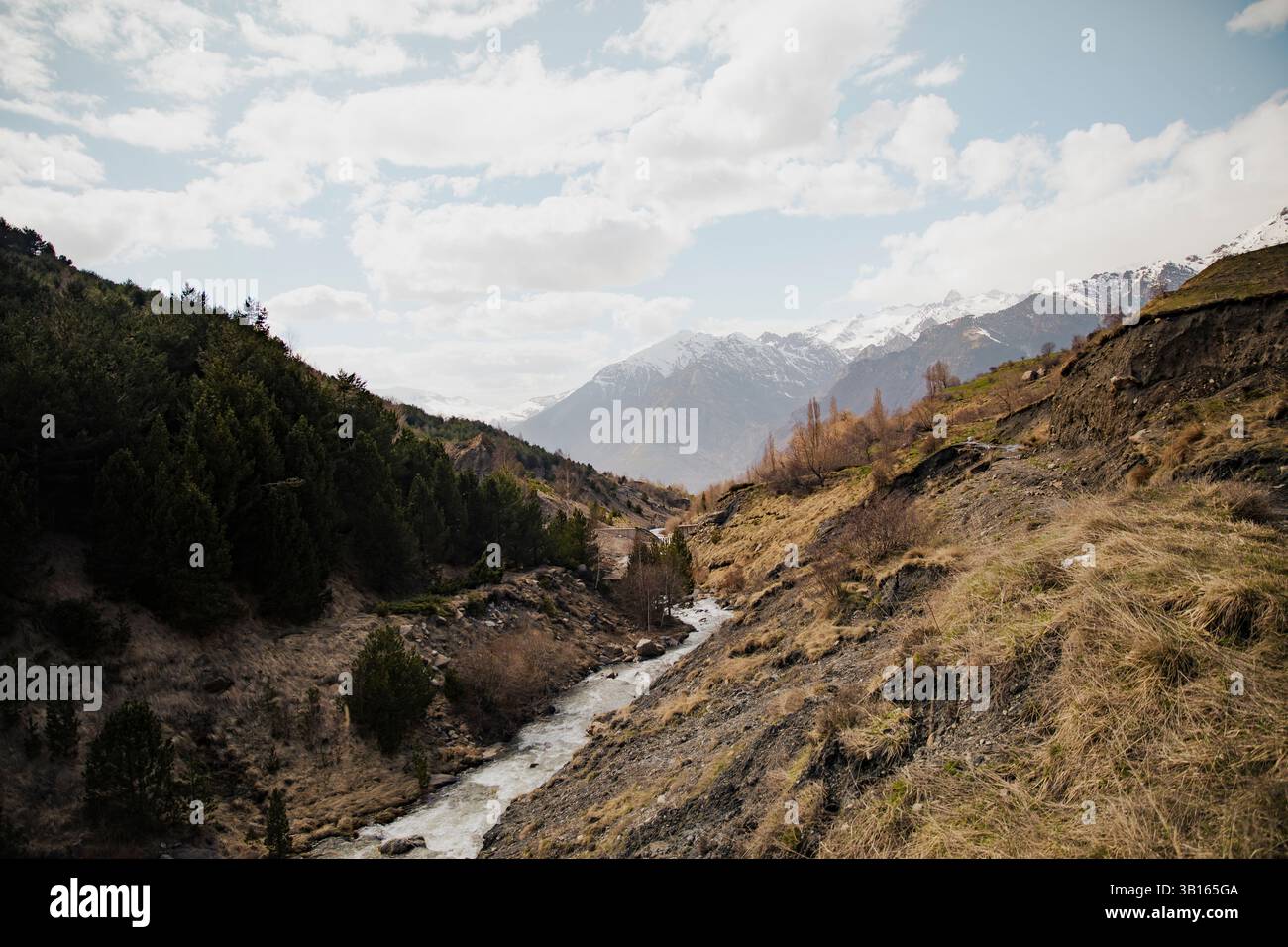 Mountain stream winding through rugged valley Stock Photo - Alamy